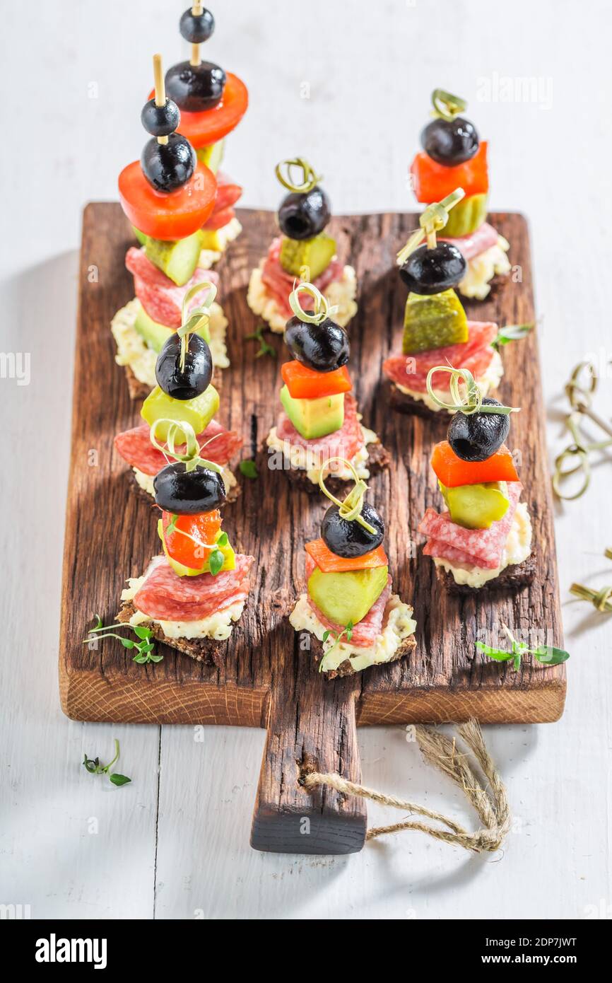 Homemade cold snacks made of vegetables and herbs on white table Stock ...