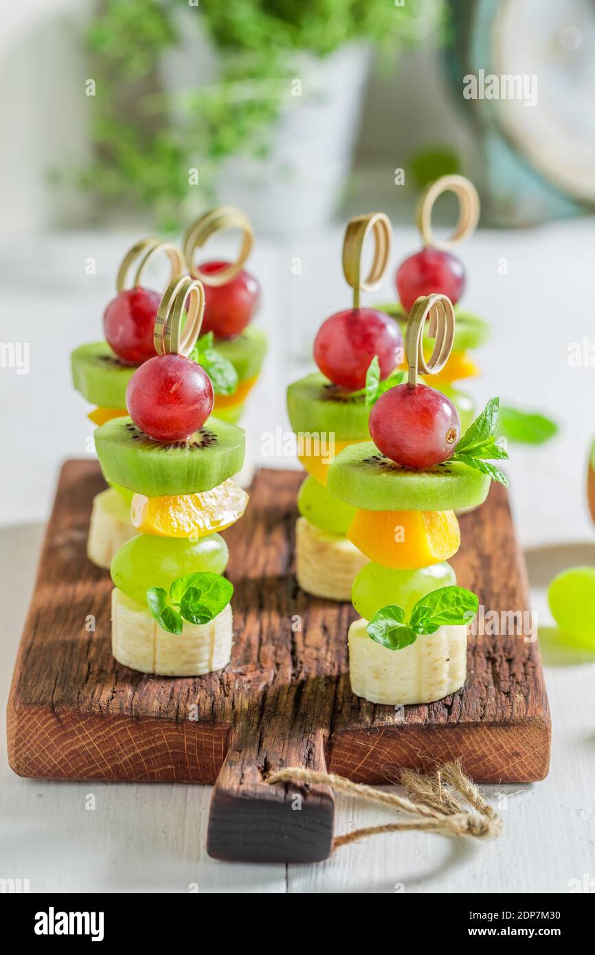 Homemade and tasty snacks made of fruits and mint on white table Stock ...