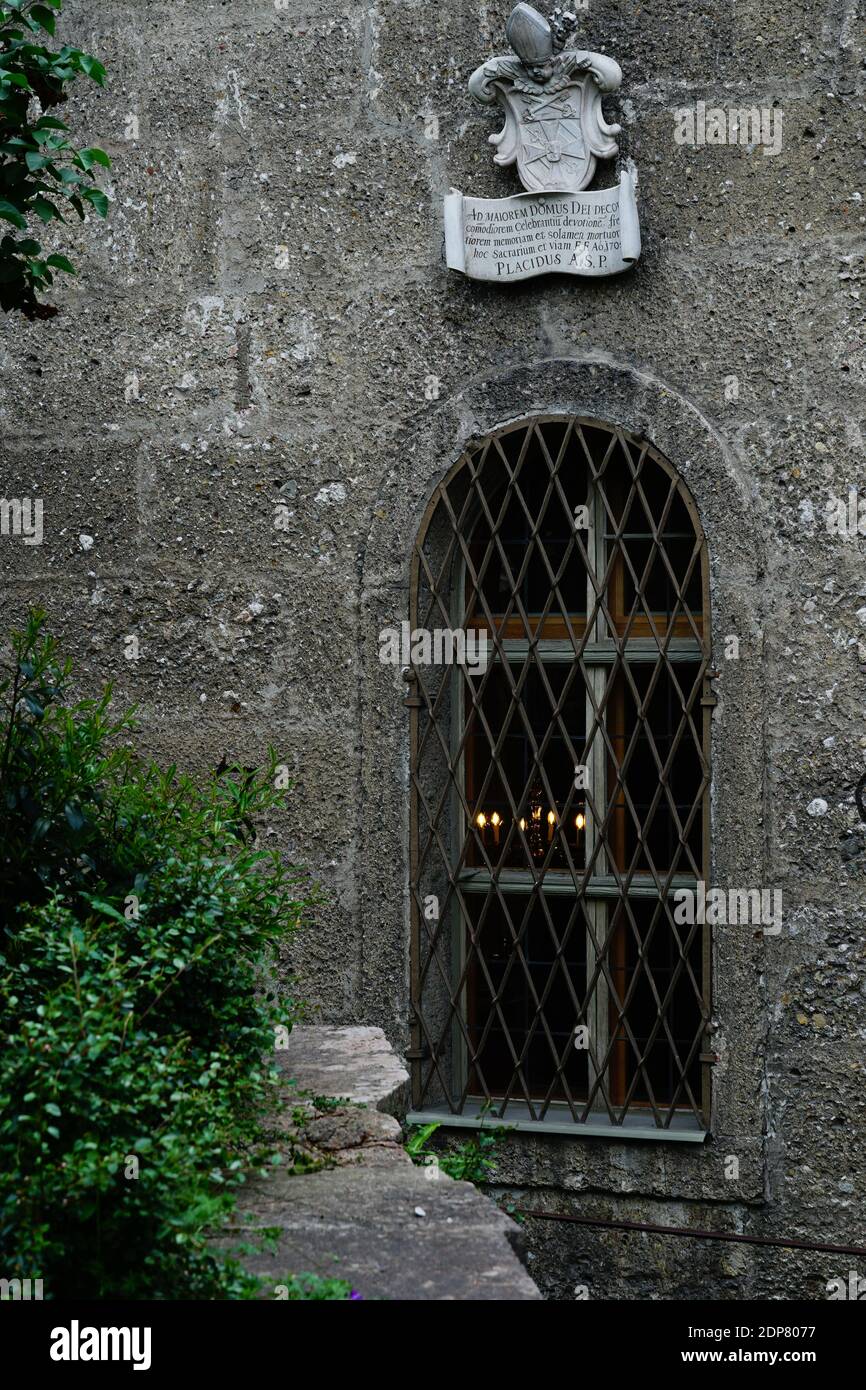 A caged arch window on a stone building Stock Photo - Alamy