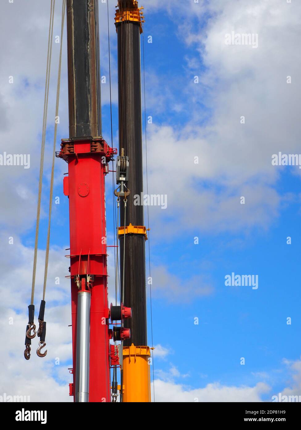Detail of a red and a black heavy-lift crane boom with hooks Stock ...