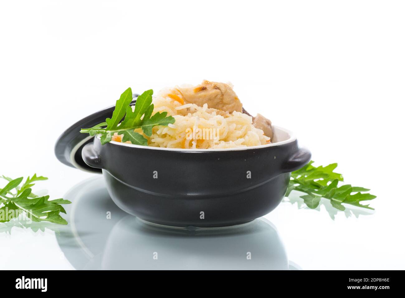 light boiled rice with vegetables and meat in a ceramic bowl isolated ...