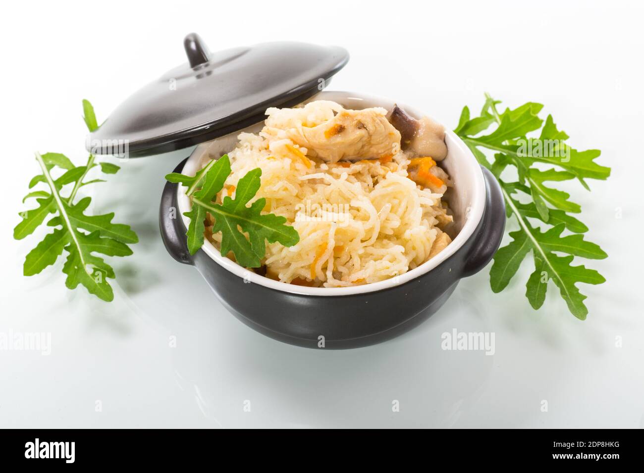 light boiled rice with vegetables and meat in a ceramic bowl isolated ...