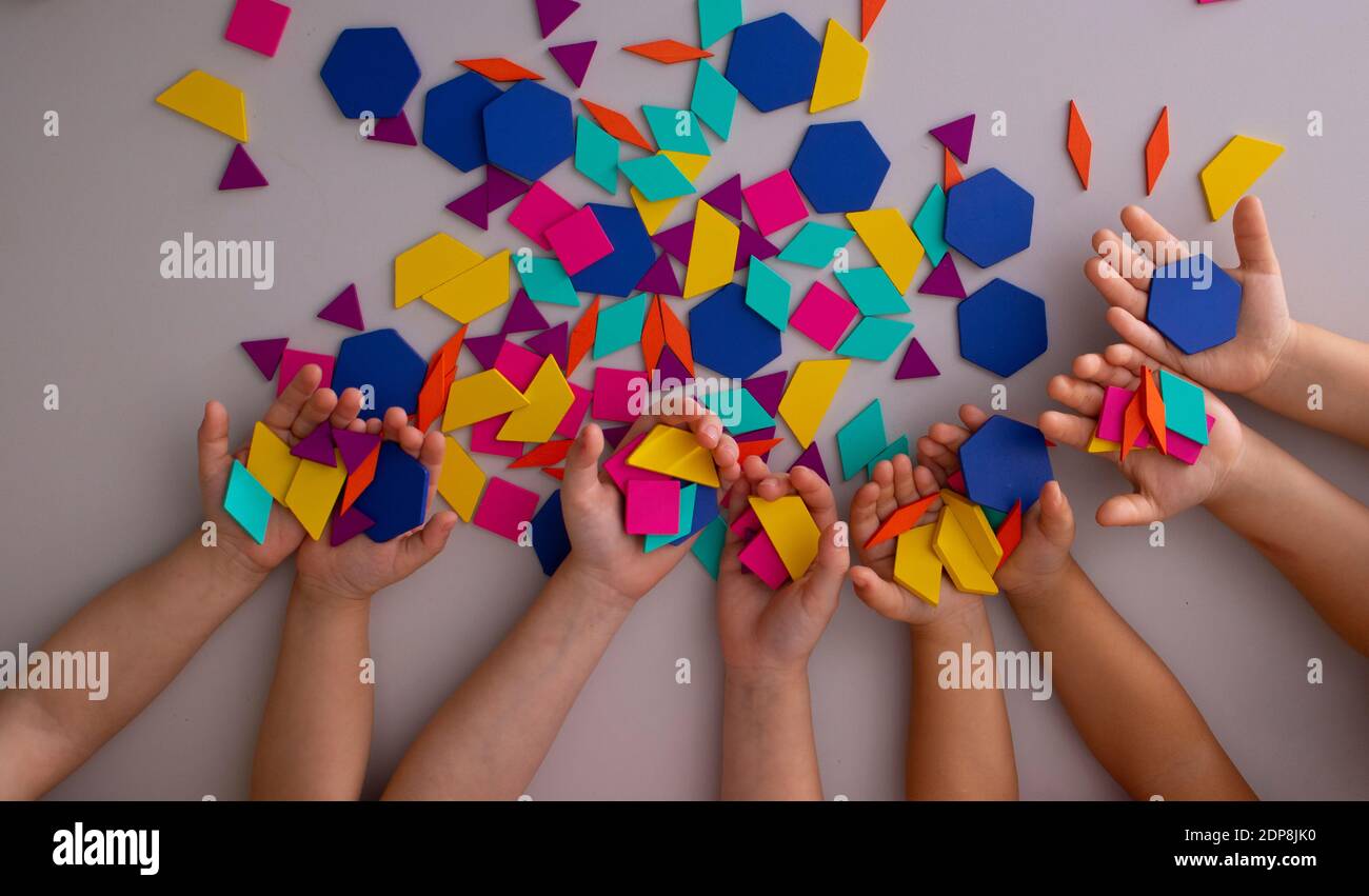 Four kids touching wooden cubes and blocks constructor. Child ...