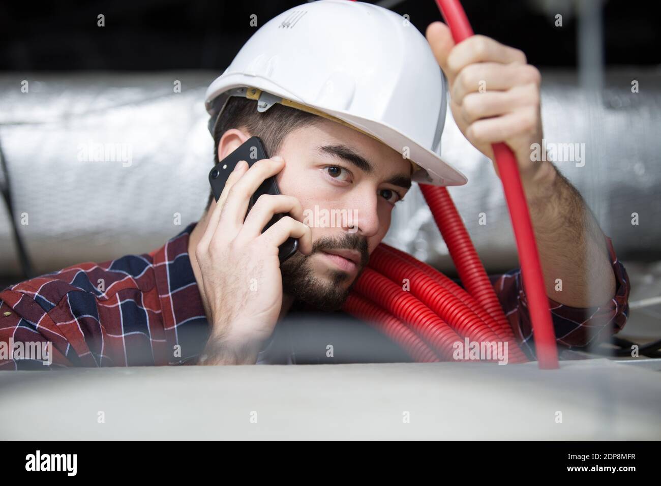 electrician contractor on the phone with cables Stock Photo - Alamy