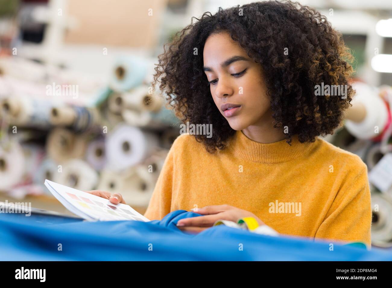 woman matching material to colour sample Stock Photo - Alamy