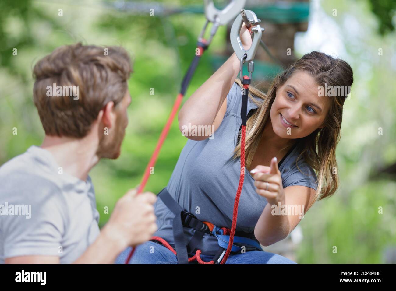 fit man and woman crossing the rope during obstacle course Stock Photo ...