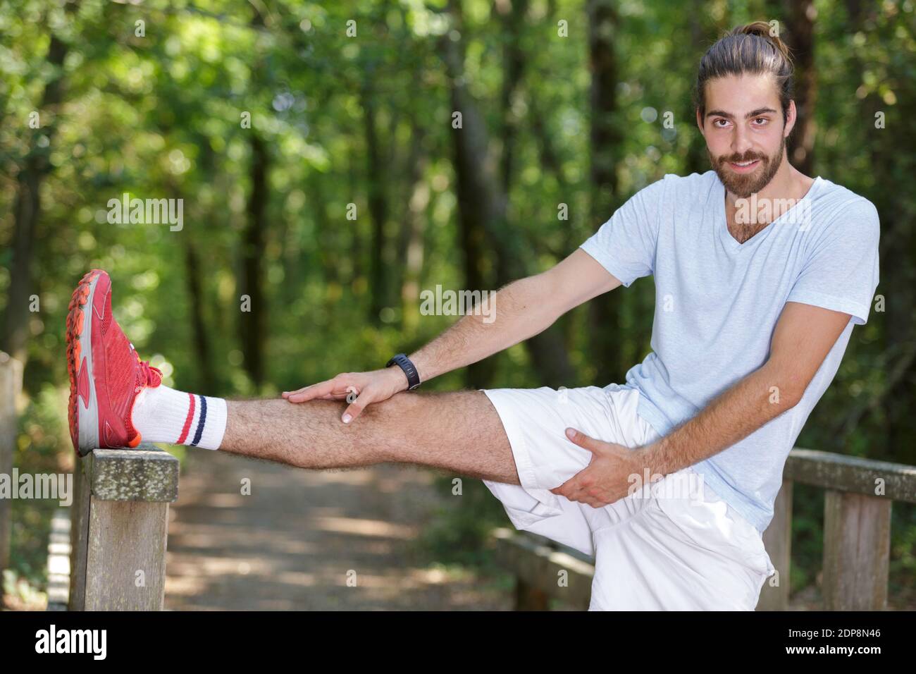 man doing leg stretches outdoor Stock Photo - Alamy