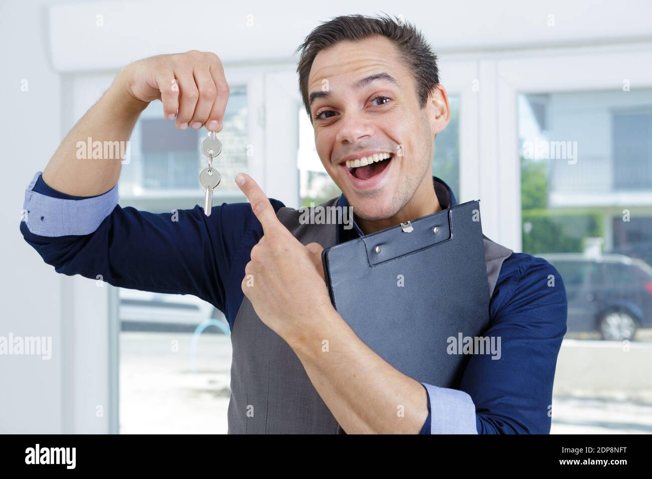 happy man with key moving to new home Stock Photo - Alamy