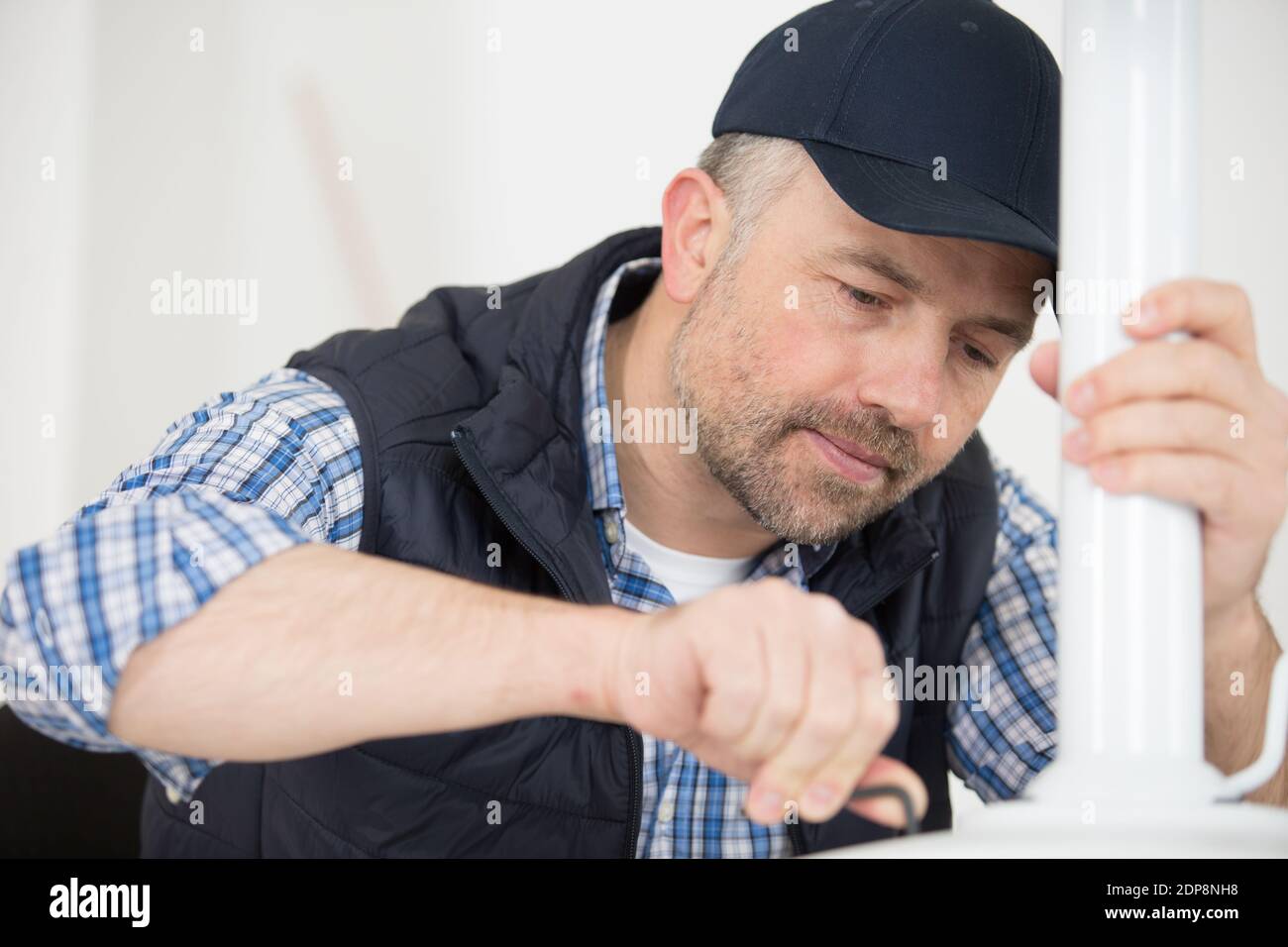 man assembling a metal chair with allen-key Stock Photo - Alamy