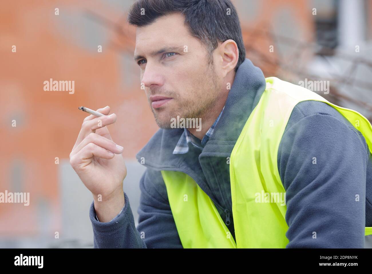 trades man smoking a cigarette Stock Photo - Alamy