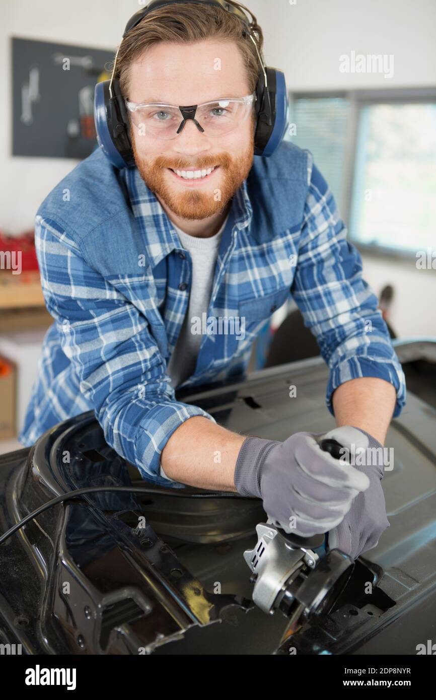 mechanic using angle grinder Stock Photo - Alamy