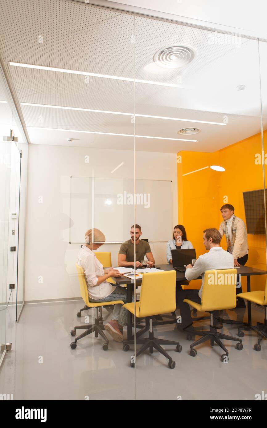 Vertical full length shot of a business team having a meeting in ...