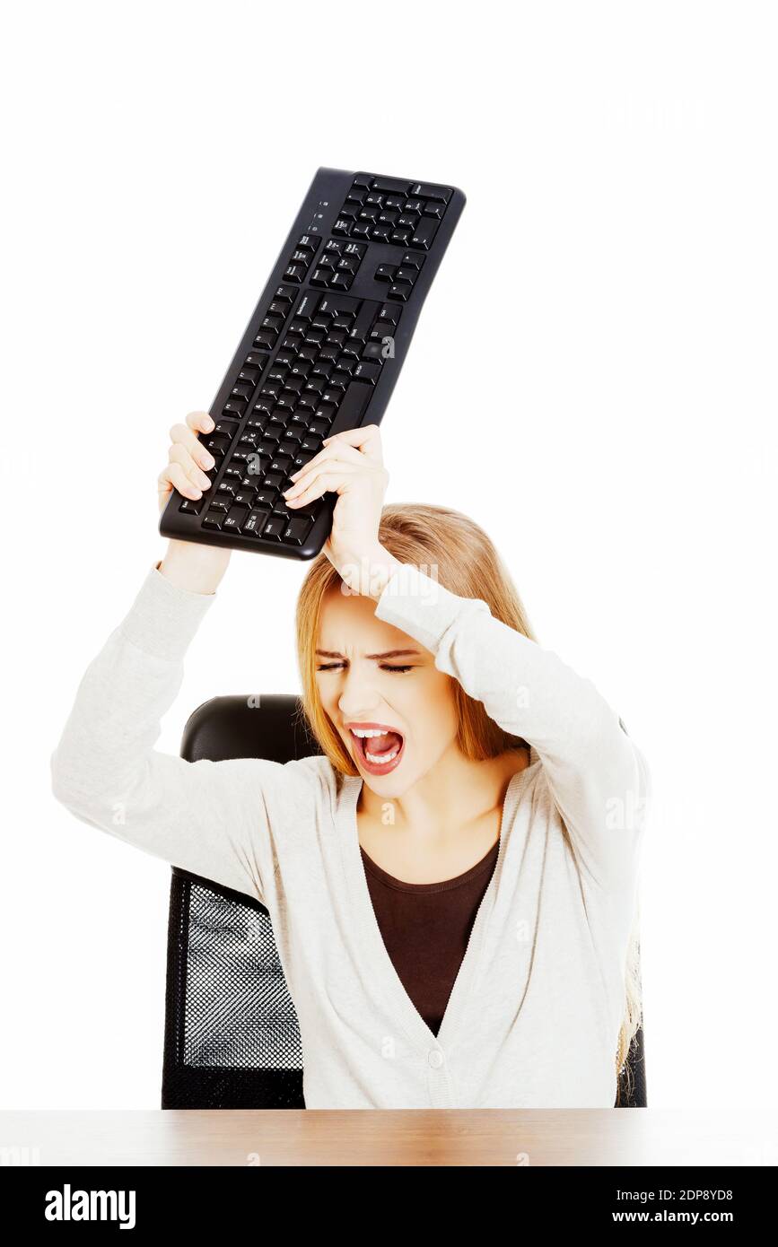 Angry Woman Breaking Keyboard Against White Background Stock Photo - Alamy