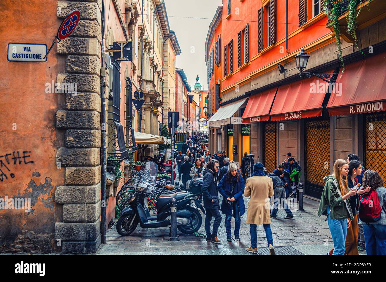 Bologna, Italy, March 17, 2019: people are walking down typical italian ...