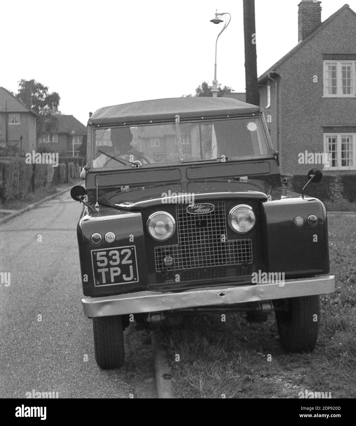 1960s, historical, a Land Rover parked up on a narrow road on a rural ...