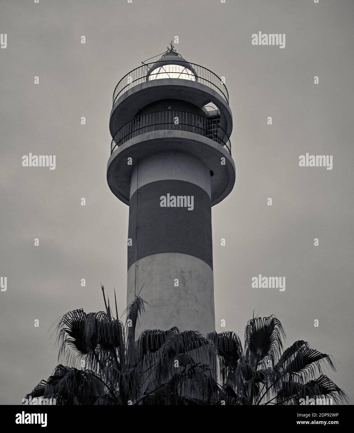 A vertical greyscale shot of the lighthouse of Torre Del Mar captured ...