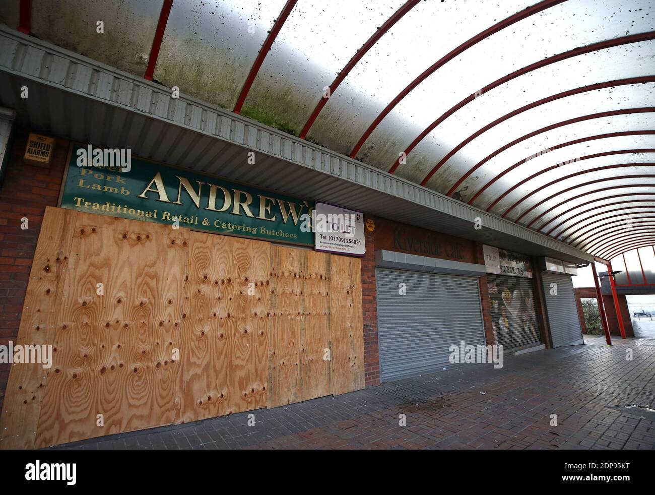 Boarded up shops inside an empty shopping precinct in Rotherham town ...