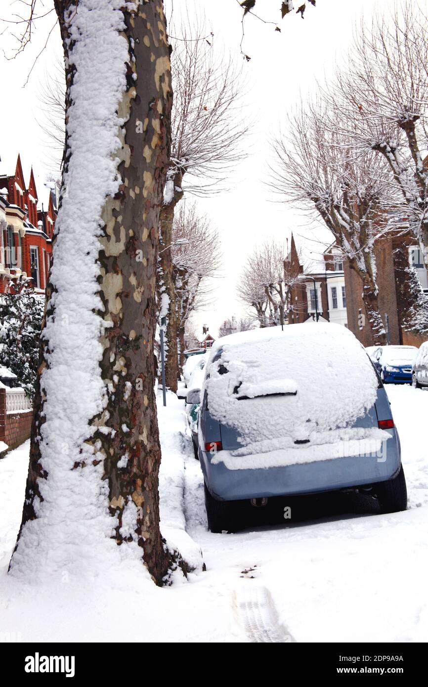 Street winter cityscape with snow terraced houses and frozen cars after ...