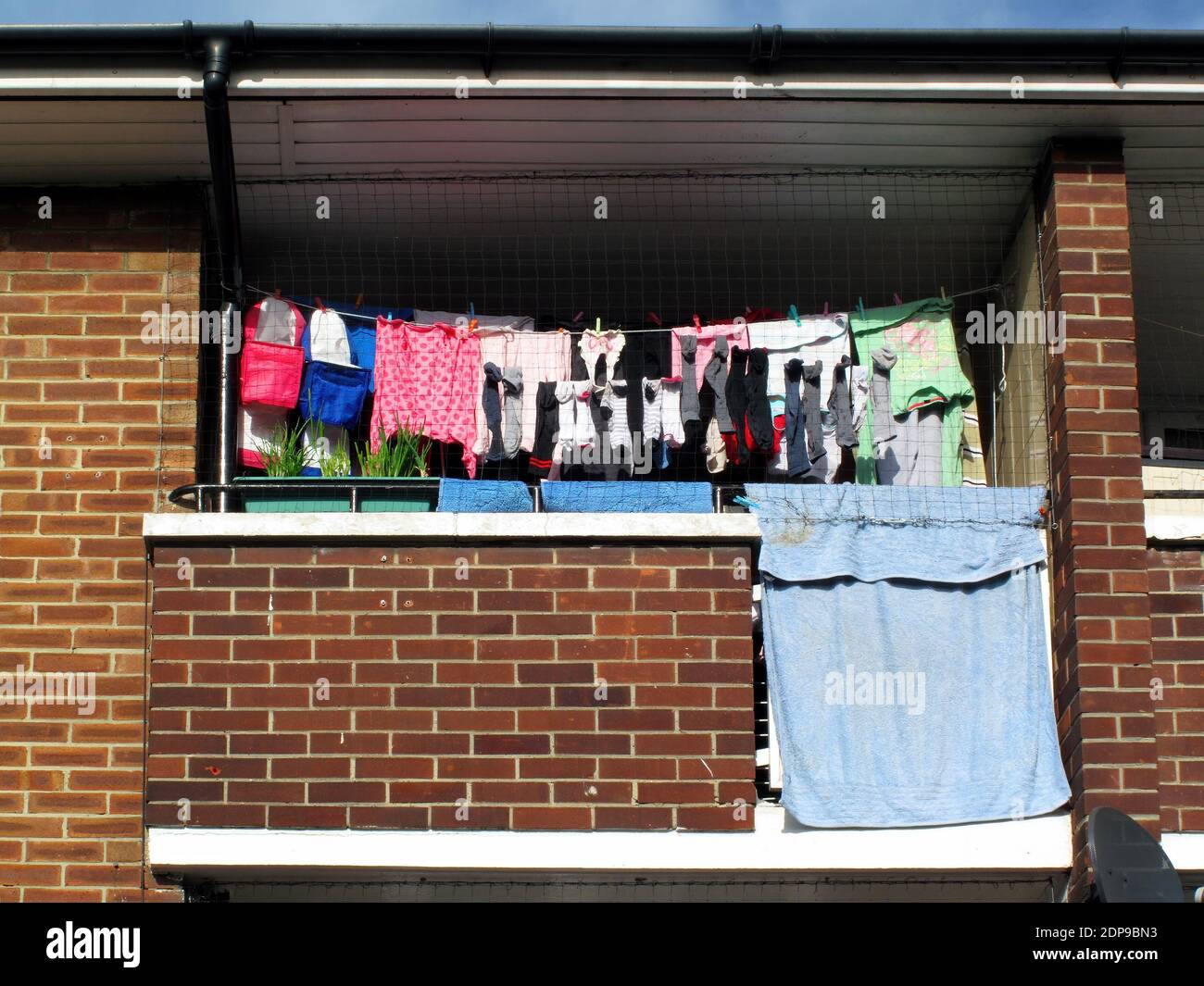 Washing hanging on a line on a balcony of a typical council flat ...