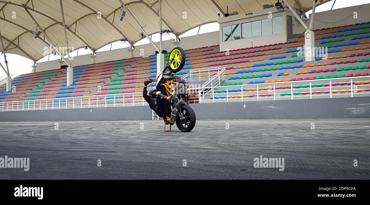 Full Length Of Biker Performing Stunt In Stadium Stock Photo - Alamy