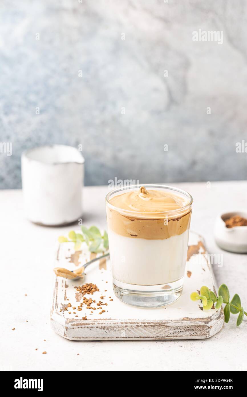 Dalgona Coffee, a cool fluffy whipped coffee in a glass. Latte espresso ...