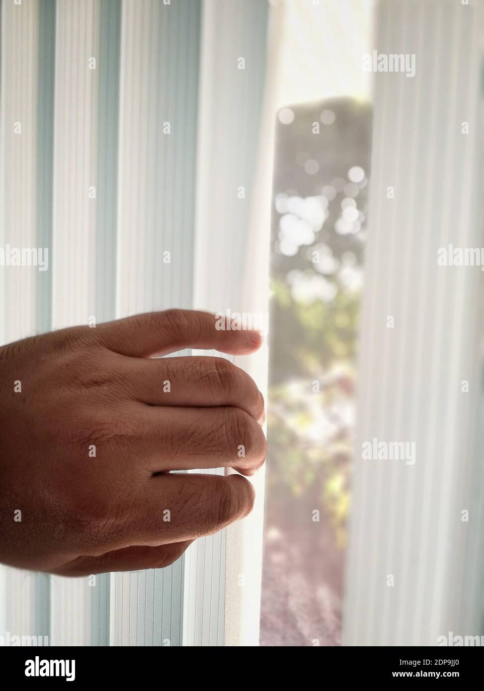 Hand opening blinds hi-res stock photography and images - Alamy