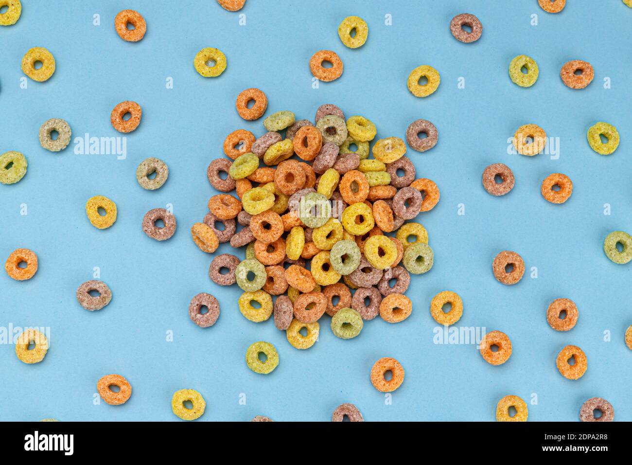 Pile of Colorful corn rings on blue background Stock Photo - Alamy