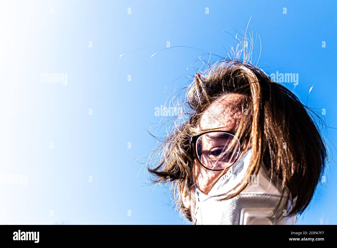 Man with disheveled hair with a face mask Stock Photo - Alamy