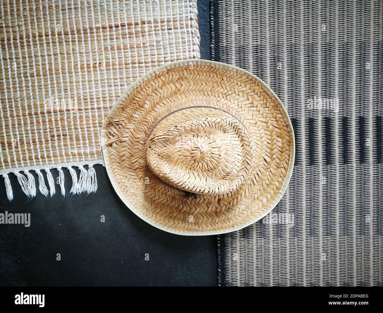 A top view closeup of a thatch hat placed on a grey surface Stock Photo - Alamy