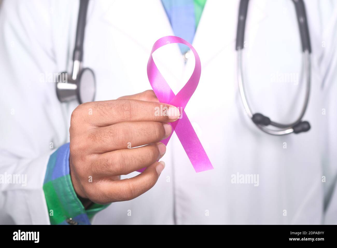 hand holding pink color HIV ribbon close up Stock Photo - Alamy