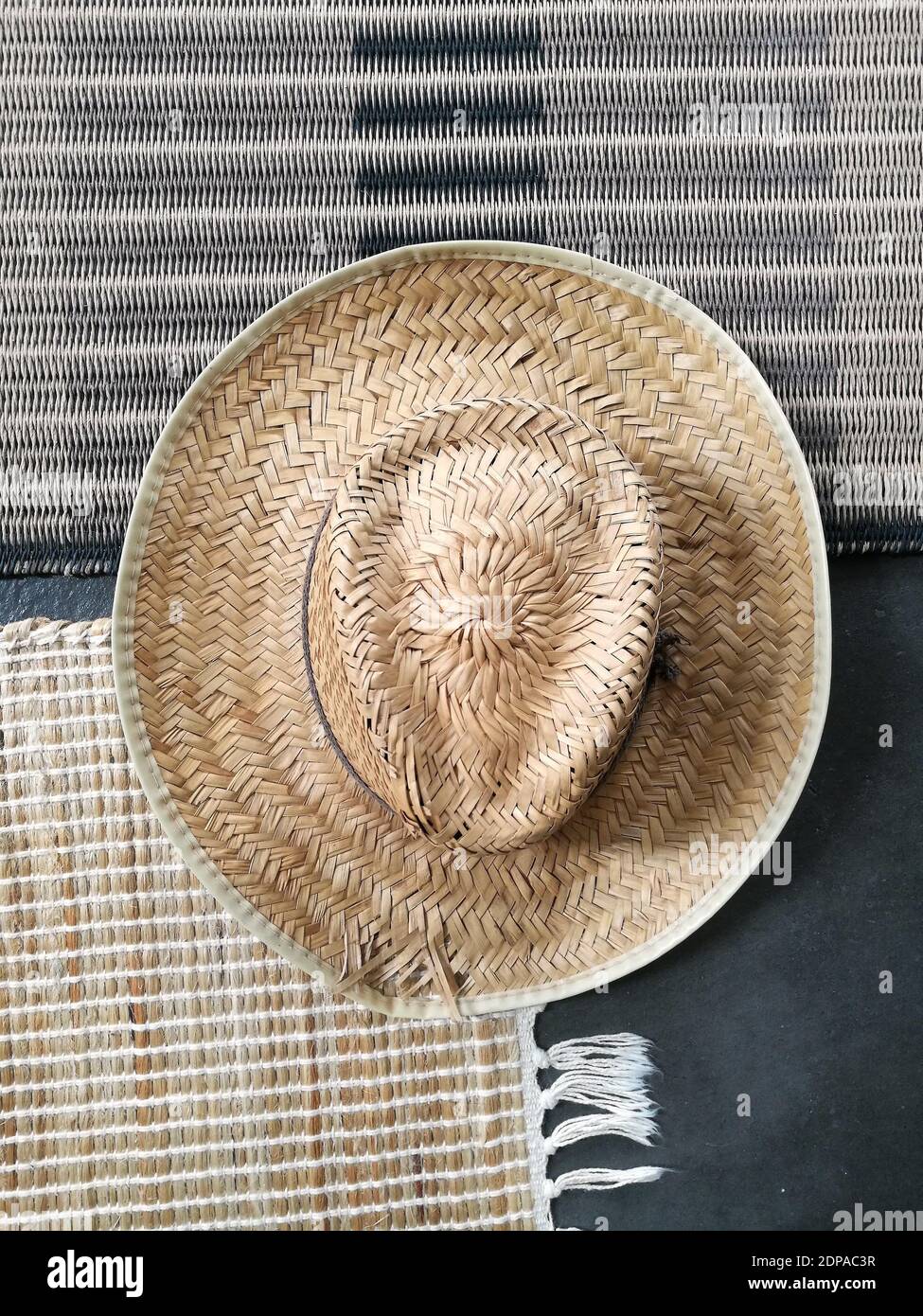 A top view closeup of a beige thatch hat placed on a grey surface Stock ...