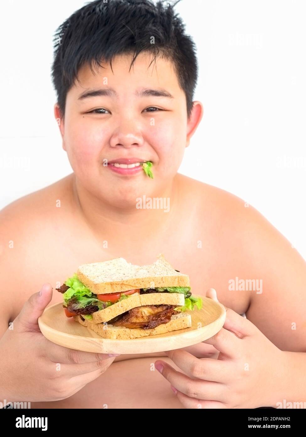 Portrait Of Smiling Boy Eating Food Against White Background Stock ...