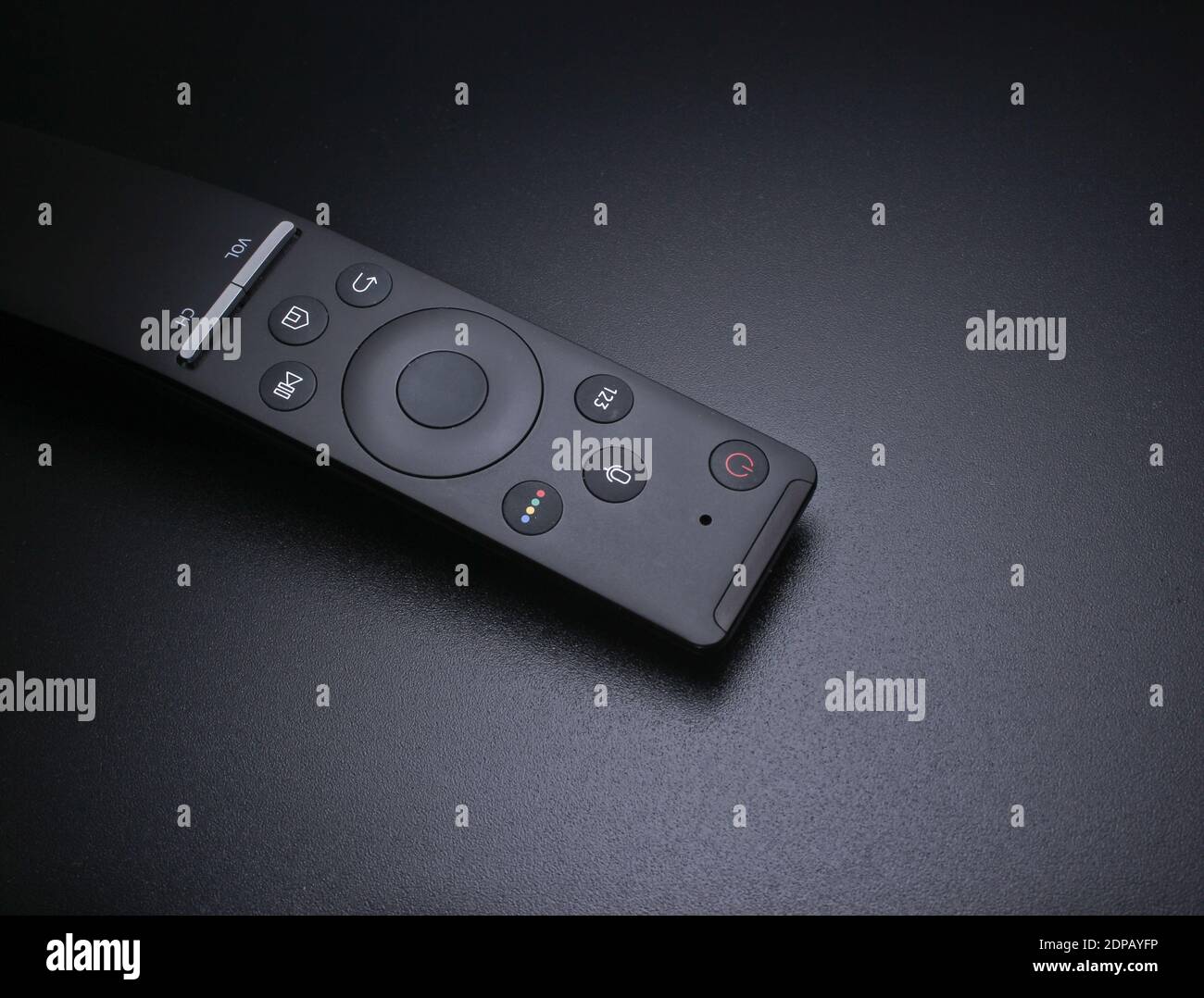 Tv remote closeup on a durk black background Stock Photo - Alamy
