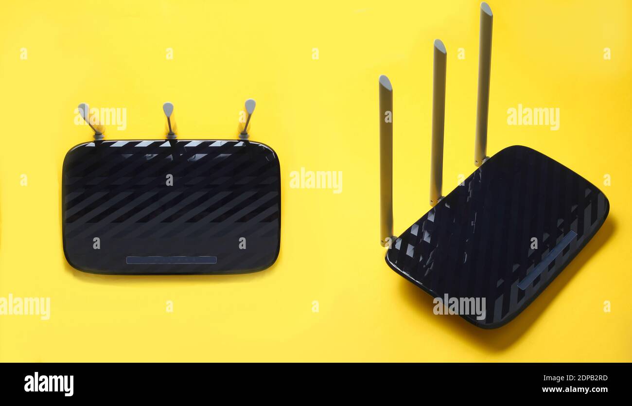 Black Three-antenna wi-fi router isolated on yellow background. Set of ...