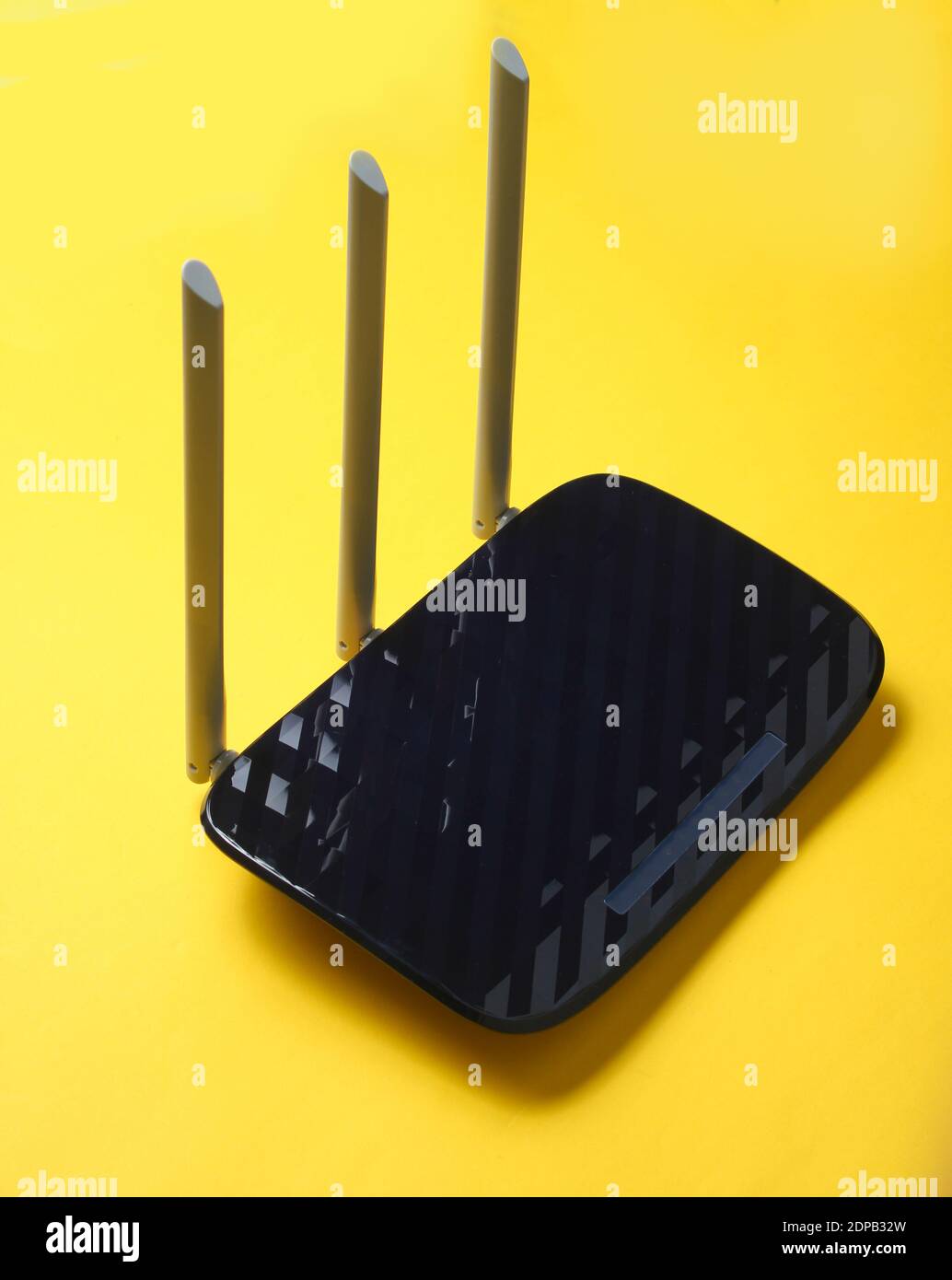 Black Three-antenna wi-fi router isolated on yellow background Stock ...