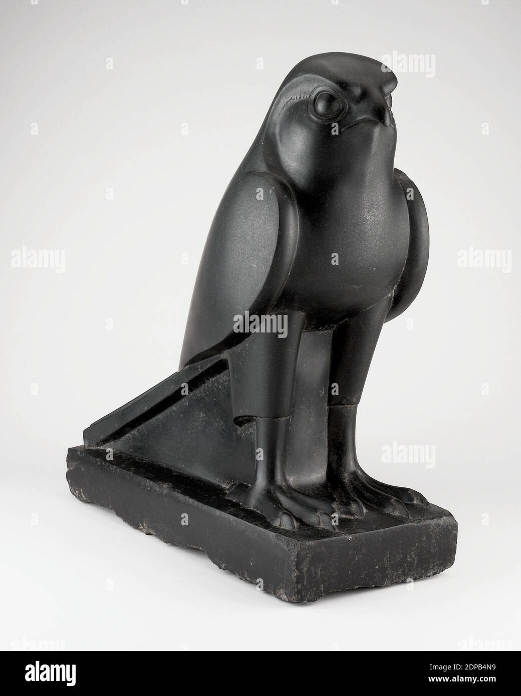 A vertical shot of an old Egyptian sculpture of a bird isolated on ...