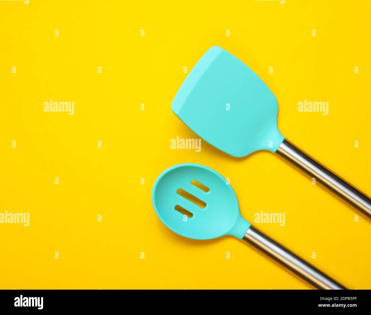 Set of tools for cooking on yellow background. Silicone paddles with ...