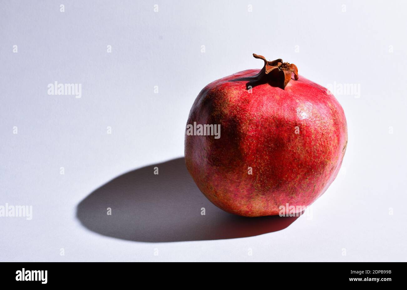 Single Pomegranate isolated with white background Stock Photo - Alamy