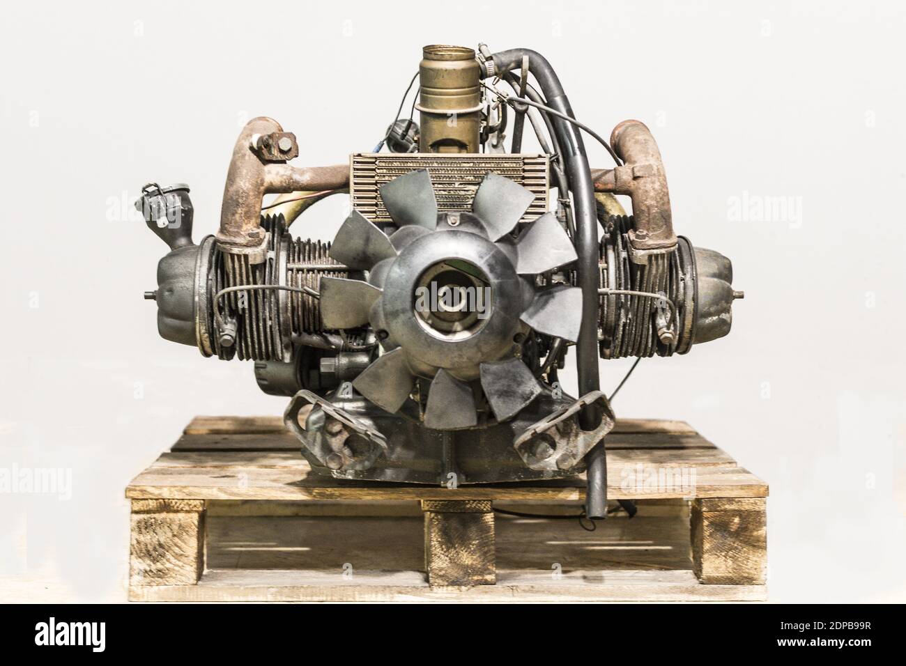 A closeup shot of a twin-cylinder gasoline motor on a white background ...
