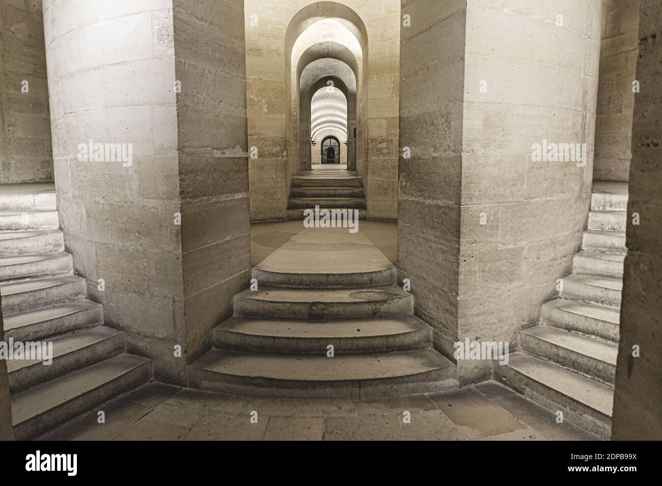 The inside of an old historic building with stairs and arches Stock ...