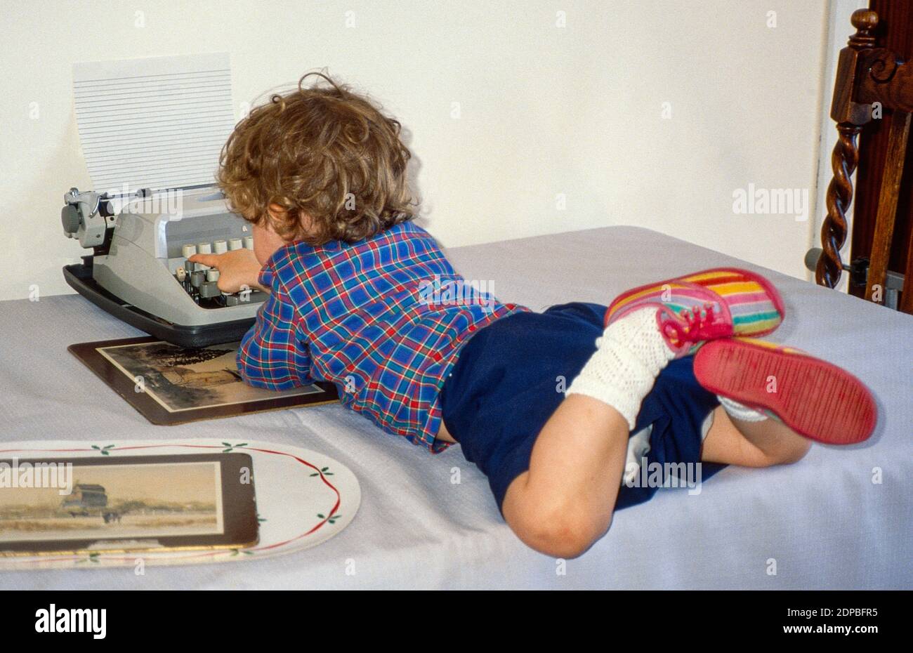 Boy tapping on a typewriter Stock Photo - Alamy