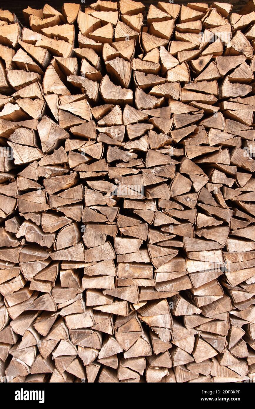Wood logs stacked in a pile - pattern Stock Photo - Alamy
