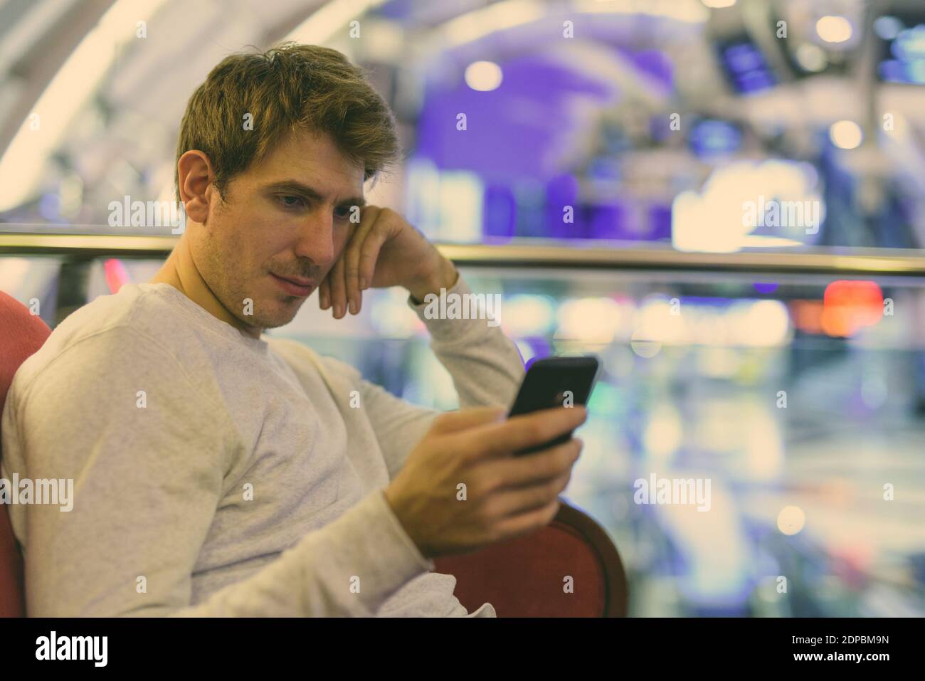 Handsome man relaxing at the mall in Bangkok, Thailand Stock Photo - Alamy