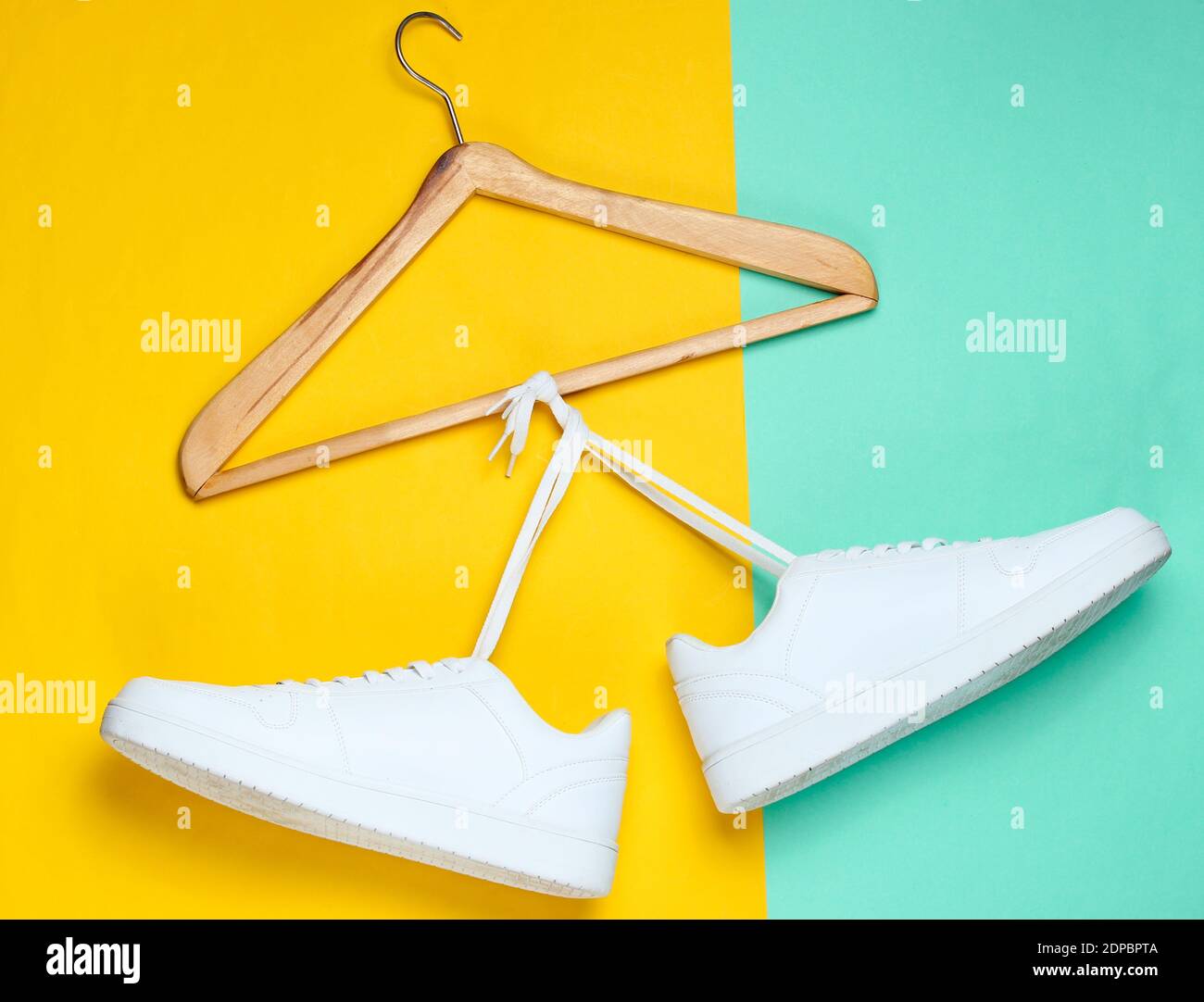 Flat Lay of Modern White Sneakers Shoes With Hanger On Pastel ...