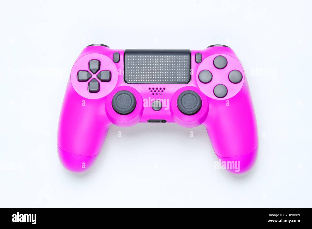Modern pink plastic gamepad (joystick) on gray background. Top view ...