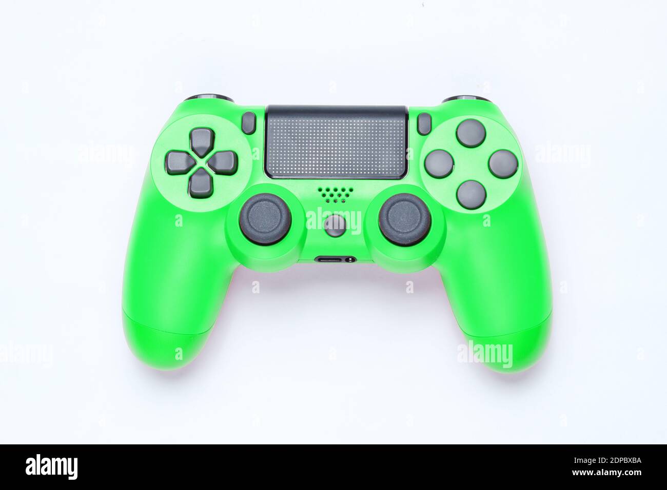 Modern green plastic gamepad (joystick) on gray background. Top view ...