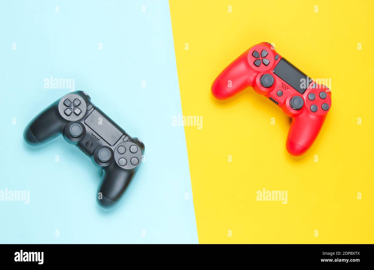 Two gamepad on a colored paper background. Video game. Minimalism, top ...