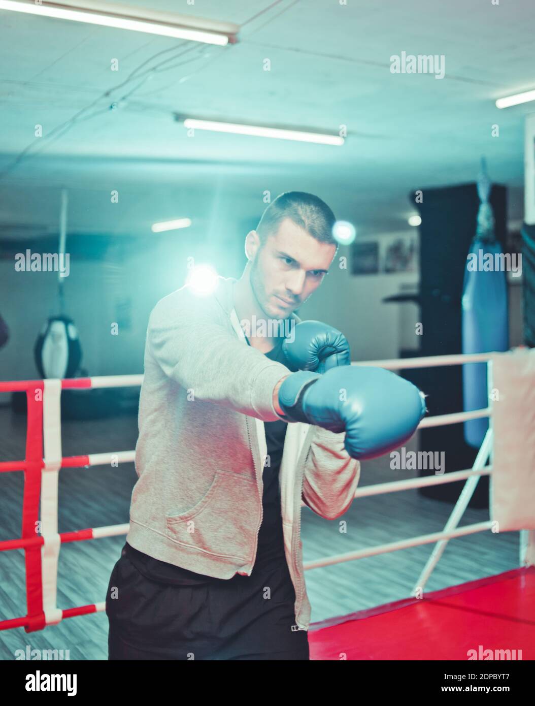 Men boxer doing shadow boxing inside boxing ring at gym. Boxer ...