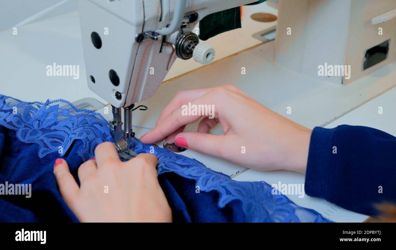 Professional tailor, fashion designer sewing clothes with sewing ...