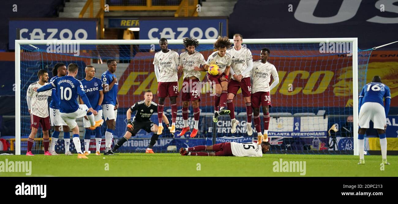 Everton's Gylfi Sigurdsson takes a free kick which hits Arsenal's David ...